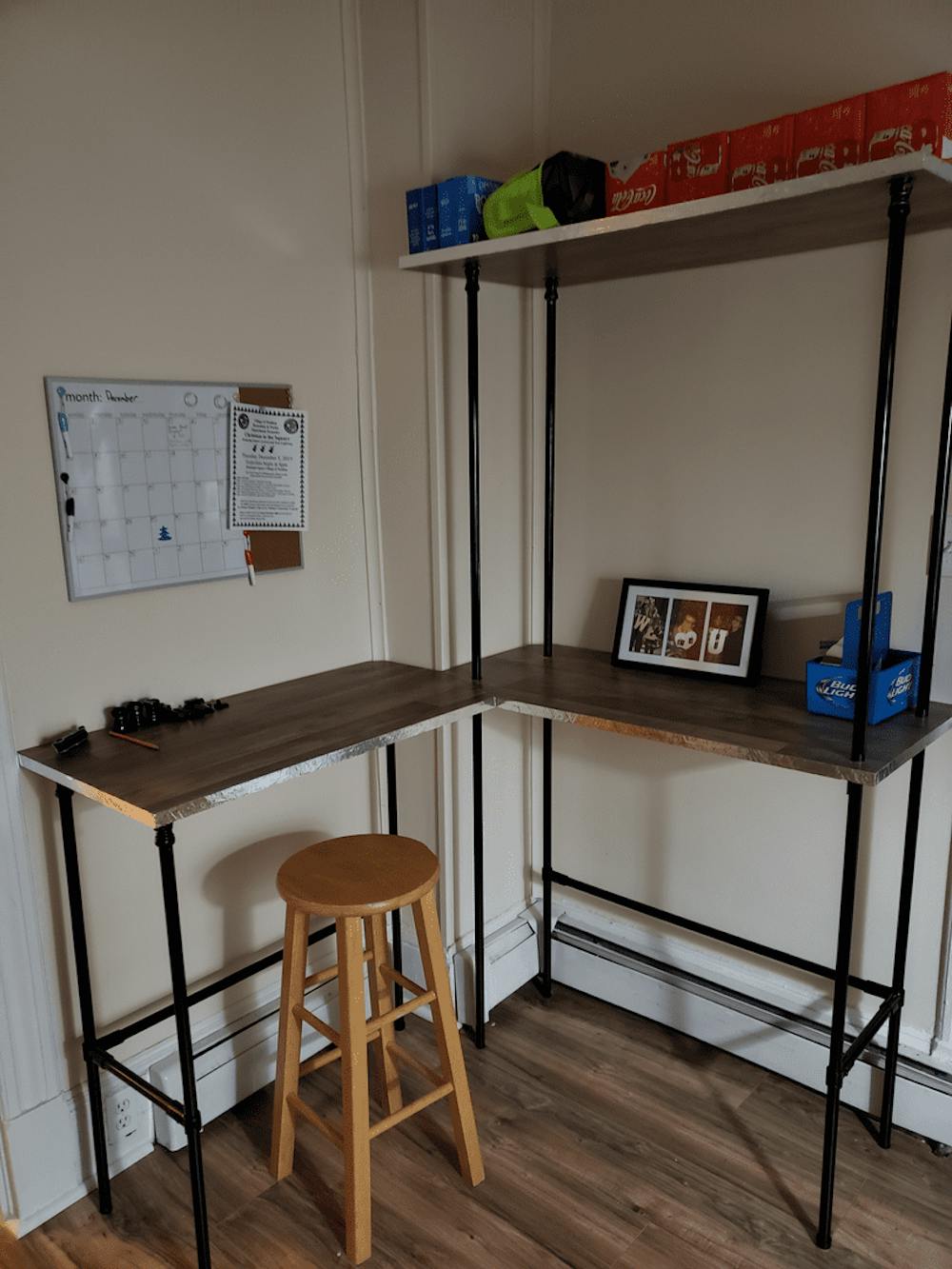 Custom pipe desk that fits this odd room corner pe...